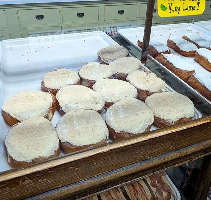 Key lime donuts sitting pretty on their wooden shelf, waiting to transport your taste buds straight to paradise.