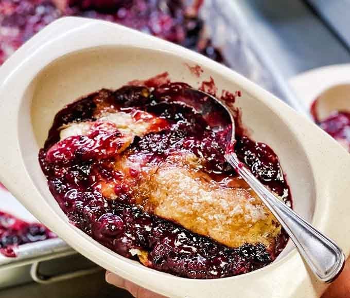 Blackberry cobbler bubbling with dark, sweet fruit that stains your spoon and possibly your soul with pure joy.