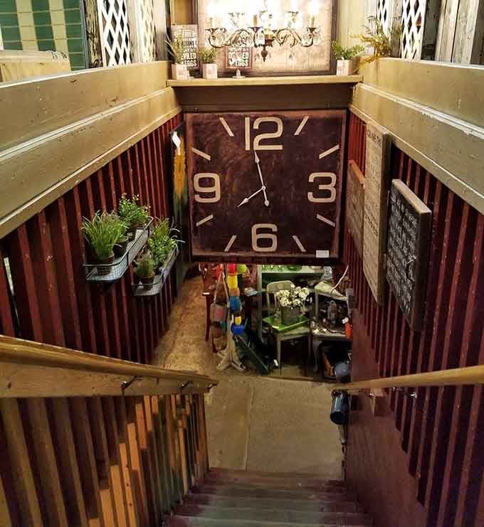 That massive clock face dominates the stairwell view, making every descent feel like stepping back through the decades themselves.
