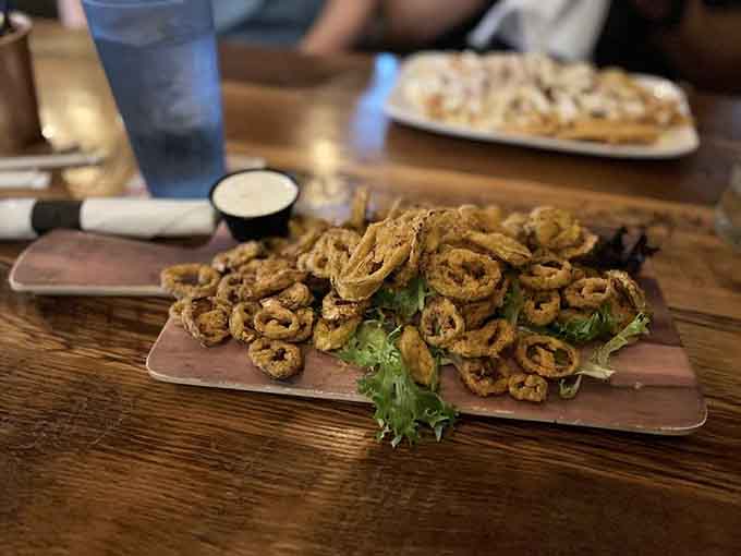 Fried banana peppers arrive piled high like golden rings of crispy, spicy perfection that disappear faster than common sense.