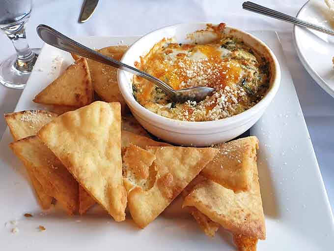 Bubbling crab dip surrounded by crispy wontons is basically a warm hug in appetizer form, perfect for sharing or not.
