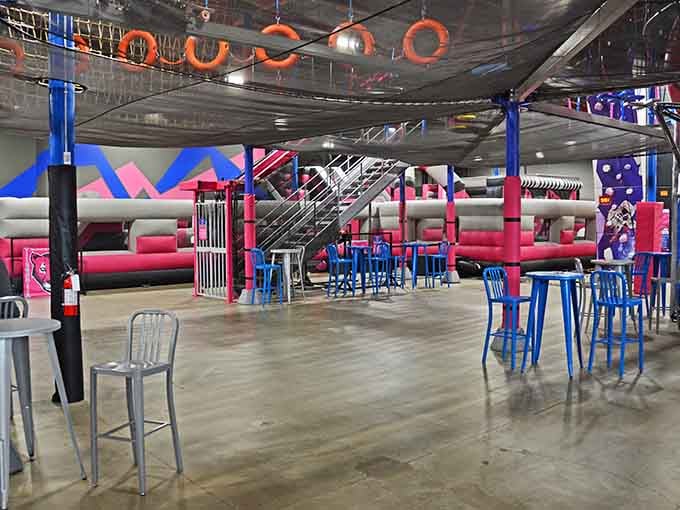 Bright seating areas offer recovery zones where exhausted warriors rest and plan their next bouncy conquest.