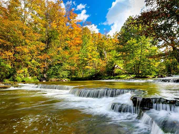 Autumn colors frame the cascading water like nature decided to show off with her entire paint collection at once.