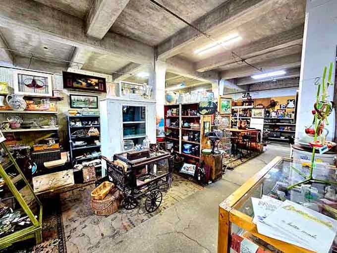Antique stoves and vintage collectibles fill this atmospheric space like a perfectly curated time capsule display.