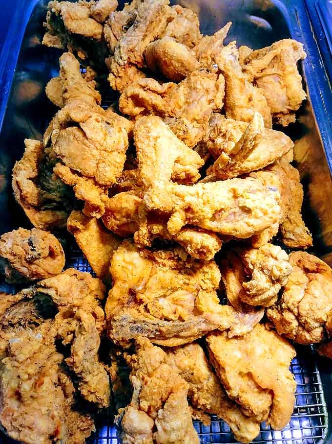That mountain of fried chicken looks like it could feed a small army or one very determined buffet enthusiast.
