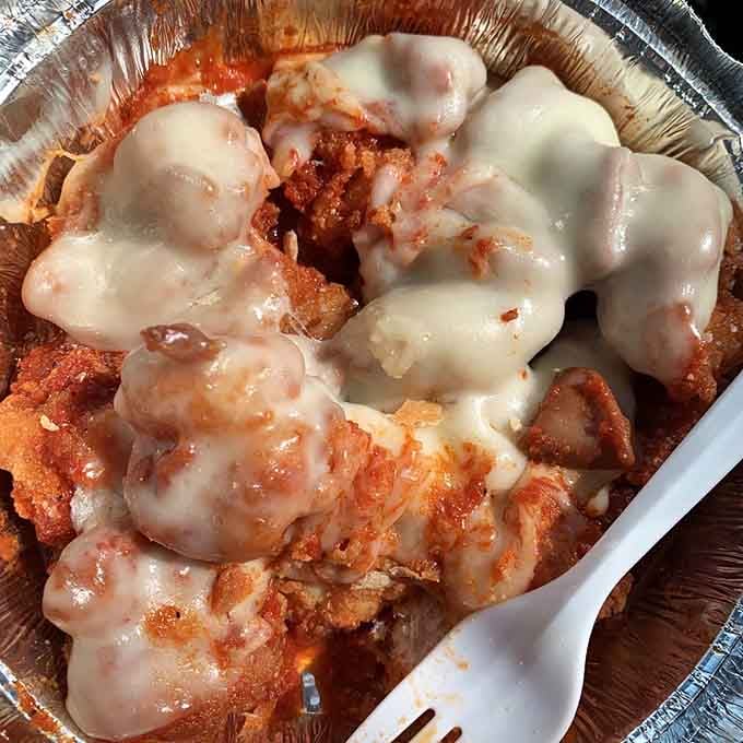 Chicken parm in a tin tray, bubbling with sauce and melted cheese. Brooklyn comfort food at its finest.