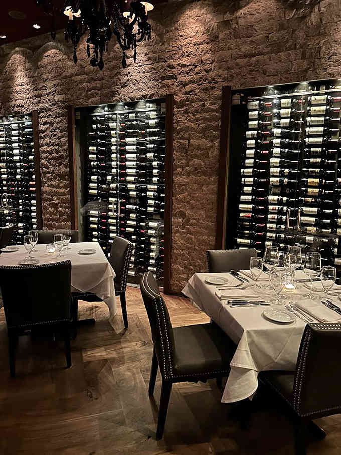 Wine displays that stretch floor to ceiling, turning bottle selection into a visual feast before the actual feast even begins.
