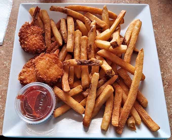 Fried butterfly shrimp and fries prove this tavern's talents extend beyond wings into crispy, golden seafood territory worth exploring thoroughly.