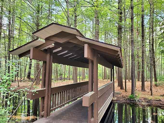 A covered bridge spans peaceful waters, proving that some architectural classics never go out of style here.
