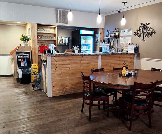 The wooden counter and metal tree decoration create a welcoming focal point in this family-friendly gathering spot.