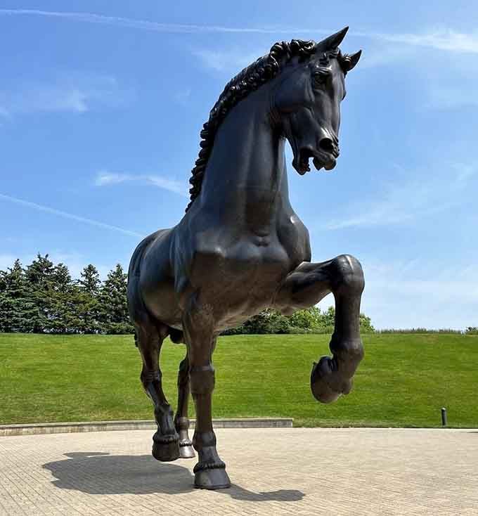This magnificent bronze stallion captures pure power and grace, frozen mid-rear like it's posing for its best angle.