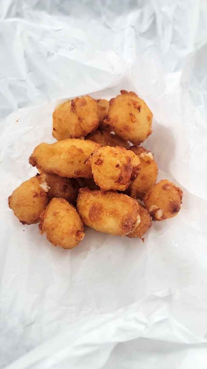 Wisconsin cheese curds: squeaky, golden, and scientifically proven to improve your entire day with every bite.