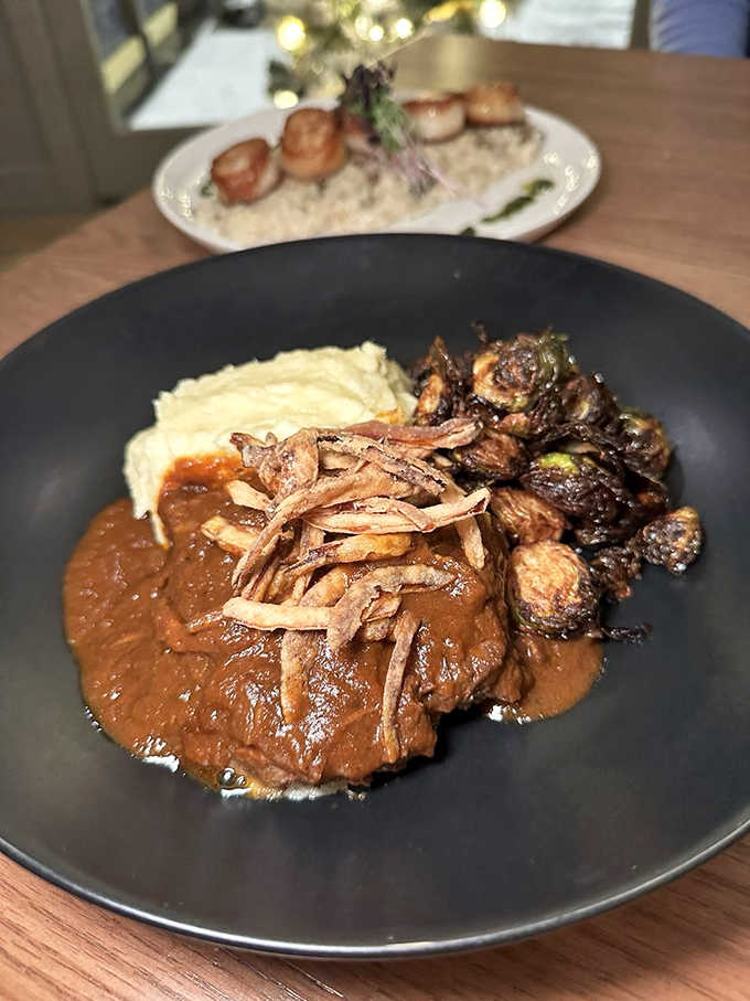 Grass-fed beef short ribs so tender they practically fall apart, accompanied by perfectly roasted Brussels sprouts and creamy sides.