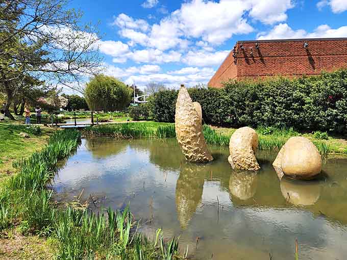 A giant snake sculpture lounging in the grass, because apparently even reptiles deserve their moment in the artistic spotlight.
