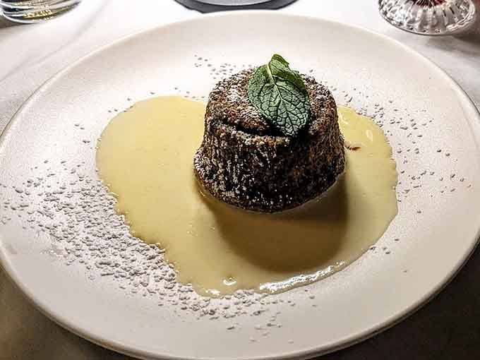 A poppy seed souffl&eacute; swimming in vanilla sauce, because apparently Austrians understand dessert on a molecular level somehow.