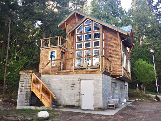 The Salish House rises like a modern treehouse dream, complete with dramatic windows that frame the Pacific Northwest perfectly.