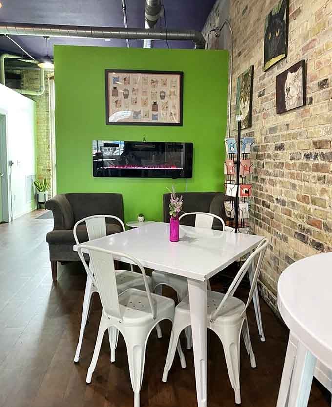 Bright green accent wall and exposed brick give this space personality that perfectly matches its quirky mission.
