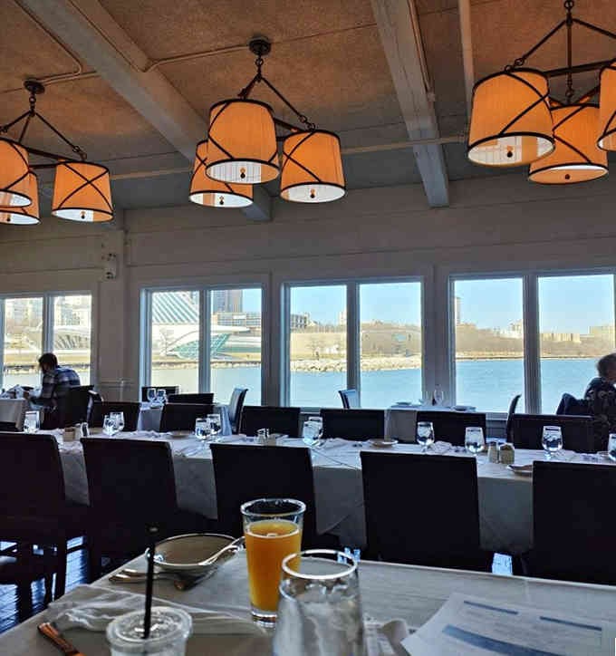 Floor-to-ceiling windows frame Lake Michigan views that rival any coastal restaurant you've ever visited.