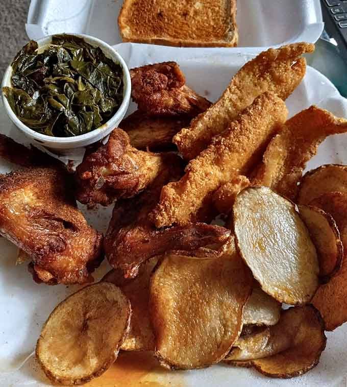 A platter that says "I came hungry and I'm leaving happy," featuring catfish, greens, and pure satisfaction.