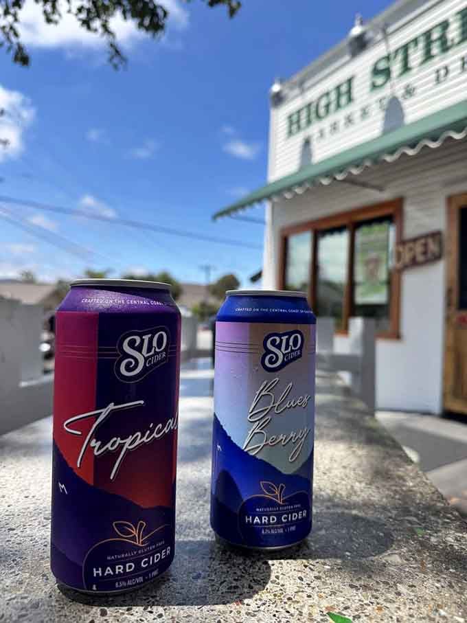 SLO Cider cans catching California rays outside the deli, because hydration comes in many delicious forms.