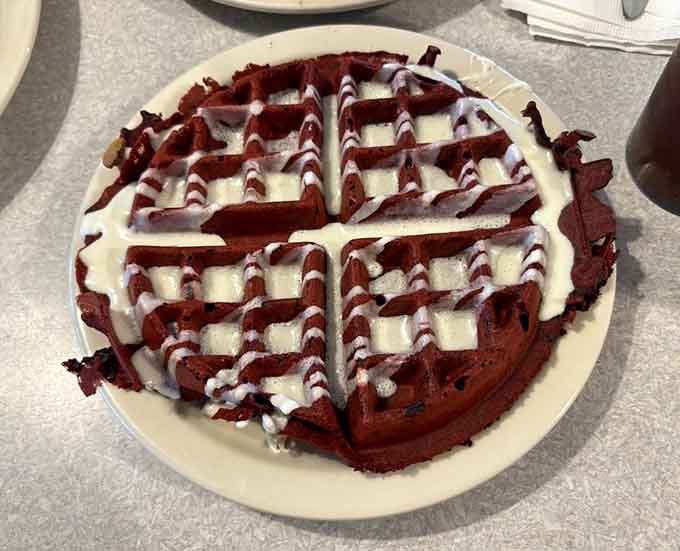 Red velvet waffle drizzled with icing, because sometimes breakfast needs to moonlight as dessert and nobody's complaining.