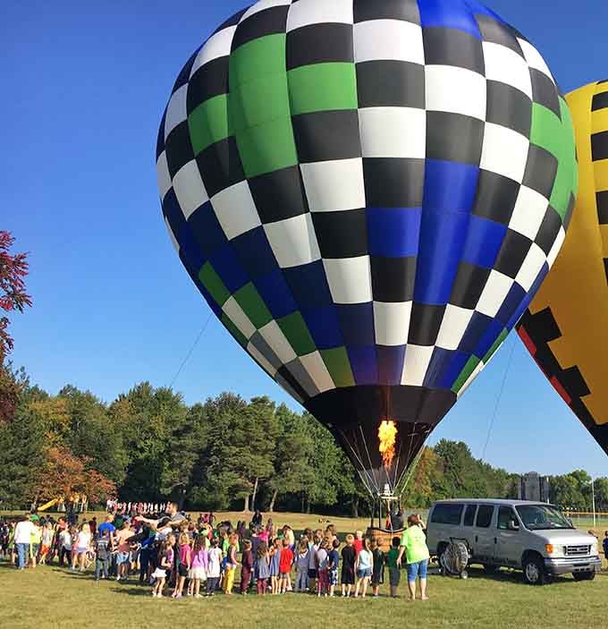 Hot air balloons gathering crowds create the kind of community moment that makes small towns absolutely shine bright.
