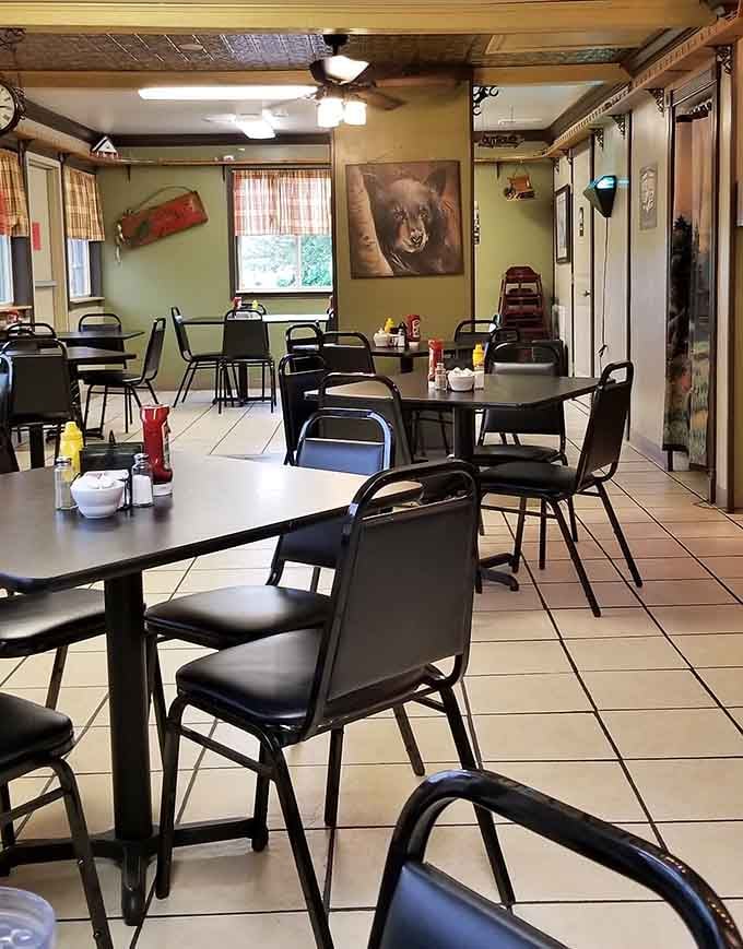 Ceiling fans, bear portraits, and tackle box decor create the perfect hunting lodge breakfast atmosphere without trying.