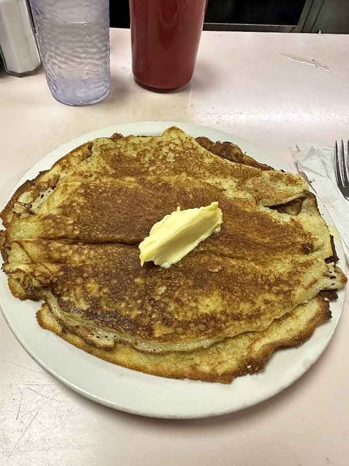 Pancakes so large they hang off the plate, golden and fluffy like your grandmother's if she actually knew how.