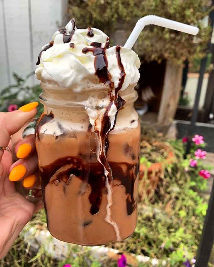 This mocha latte shake is topped with enough whipped cream and chocolate to qualify as dessert, breakfast, and therapy combined.