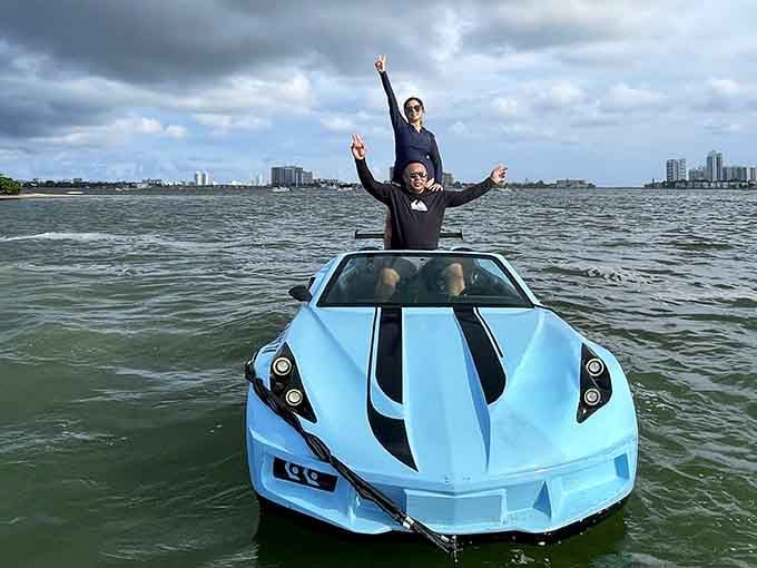 Couple goals redefined: standing together in a baby blue jet car, creating memories that'll outlast any restaurant reservation.
