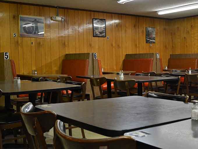 Numbered booths and simple tables create a cafeteria-style setup that's all about function over fancy.