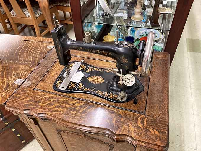 An ornate sewing machine cabinet showcasing the days when mending clothes was an art form, not a lost skill.