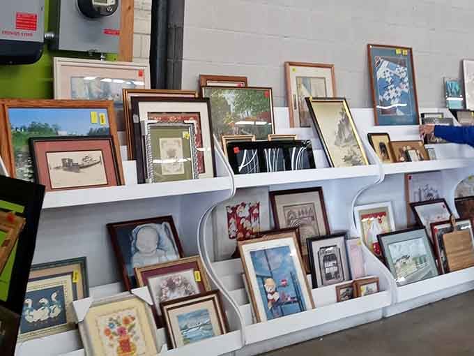 Framed art waiting for walls, like actors backstage preparing for their big debut in your hallway.