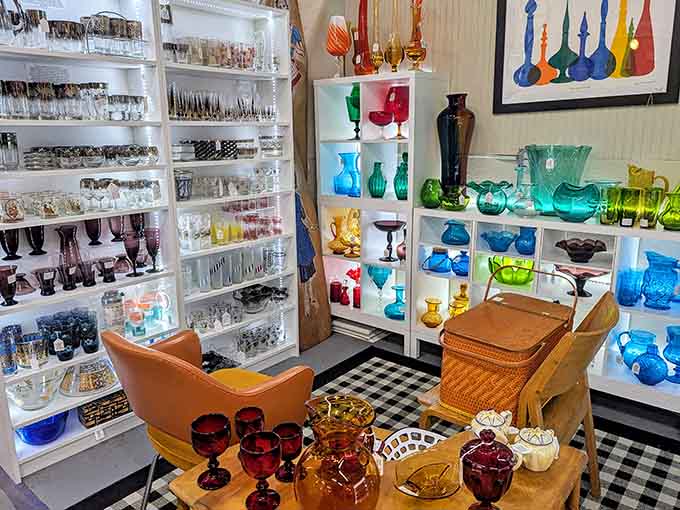 Colorful vintage glassware catches light beautifully, turning ordinary shelves into rainbow displays that demand your immediate attention.