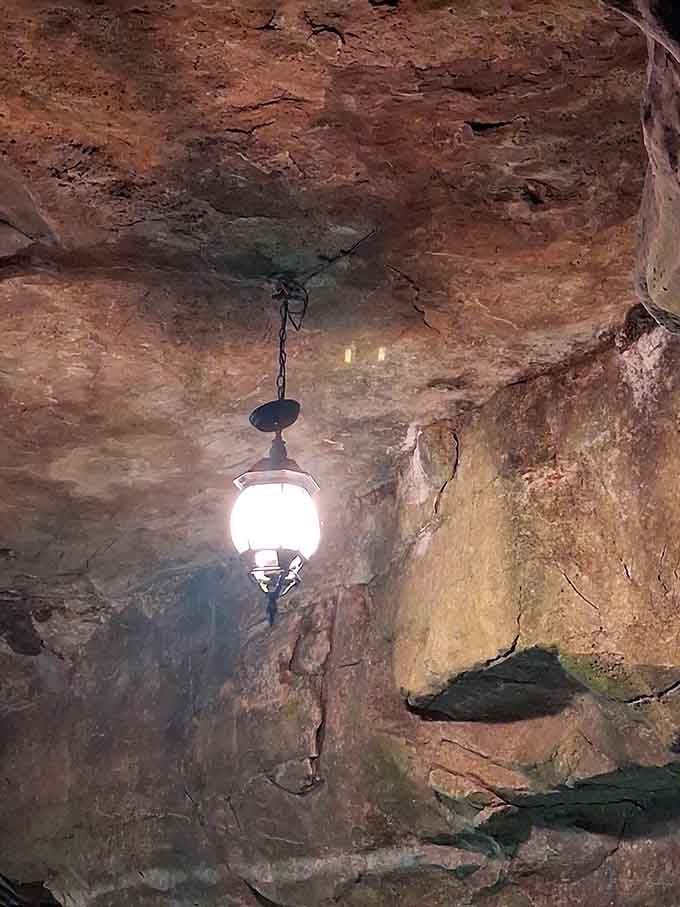 Vintage lighting fixtures hang from cave ceilings, remnants from the era when people danced underground nightly.