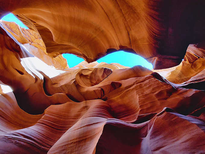 Sandstone flows like silk curtains, proof that water and time are the universe's most patient sculptors.