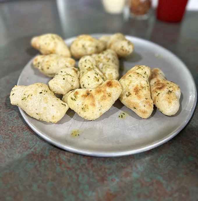 Garlic knots so buttery and aromatic, they could make a vampire reconsider their entire lifestyle choice.