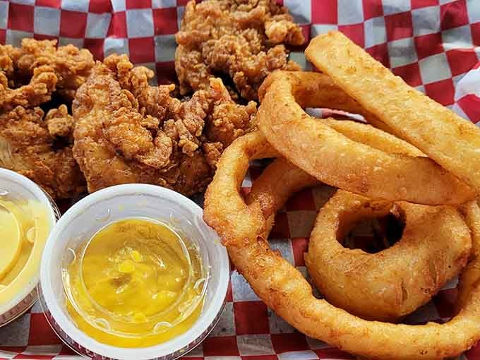 Crispy fried chicken alongside perfect onion rings, a Southern combination that never gets old or boring.