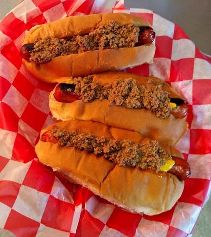 Hot dogs topped with chili and mustard, because Mac Smith's knows you can't have too many delicious options.