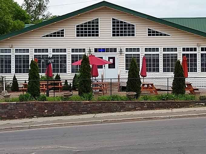 Red umbrellas and picnic tables signal the kind of casual dining where nobody judges your elastic waistband.