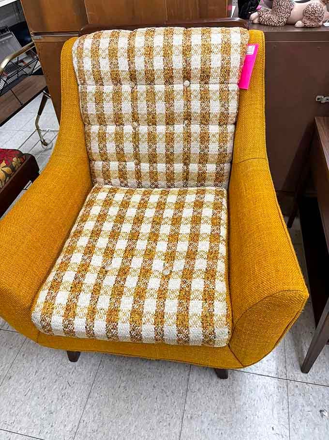 That mustard-yellow chair screams 1970s louder than a disco ball at a roller rink birthday party.