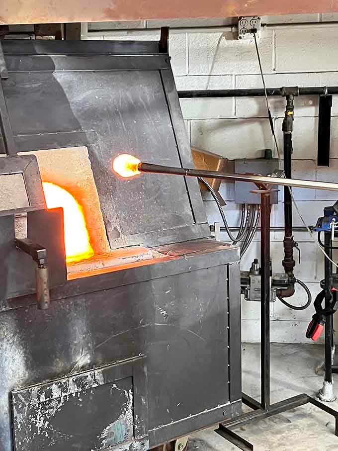 Fresh from the furnace, glowing glass awaits its transformation into something beautiful through skilled hands and tools.