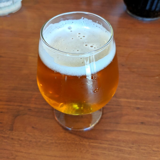 That golden glow means relaxation is just one sip away from a perfect pizza experience ahead.