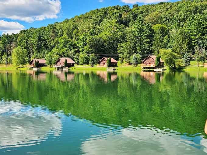 Cabins reflected in still water, looking like a postcard your jealous friends will definitely want to see.