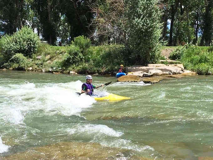 Kayakers navigate the Uncompahgre's rapids, proving adventure doesn't retire when you do in this active community.