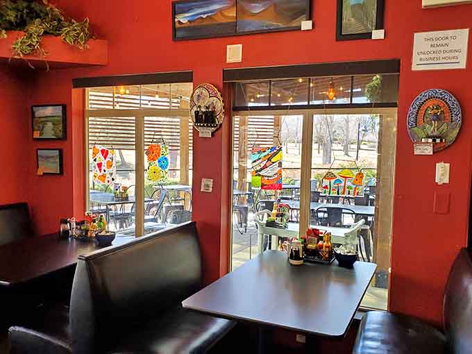 Vibrant red walls and local artwork create a dining room that feels alive with community and conversation.