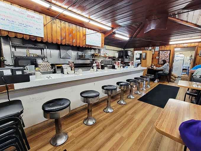 Classic diner counter seating with chrome stools invites you to sit, stay awhile, and watch the breakfast magic happen.