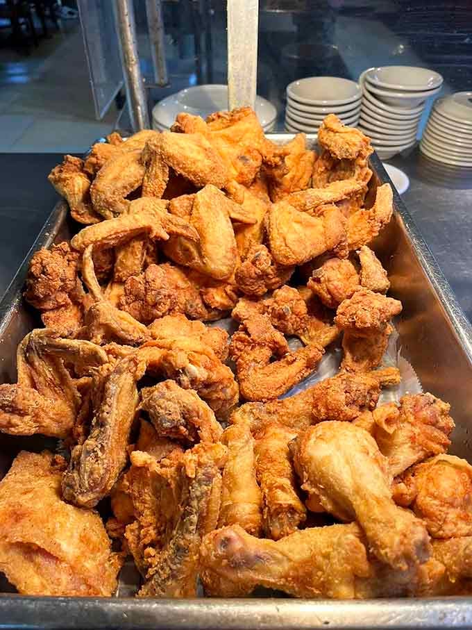 That mountain of golden fried chicken could feed your entire family reunion with leftovers for days.