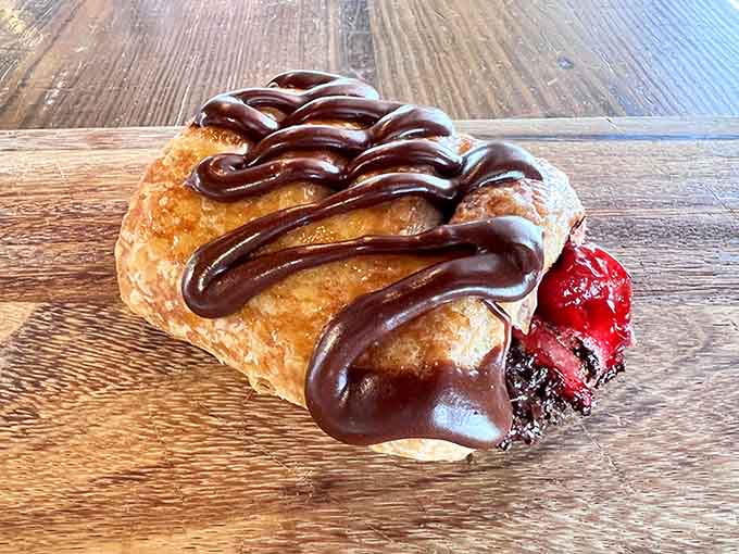 Chocolate drizzle meets cherry filling in a pastry that's basically edible happiness wrapped in flaky dough.