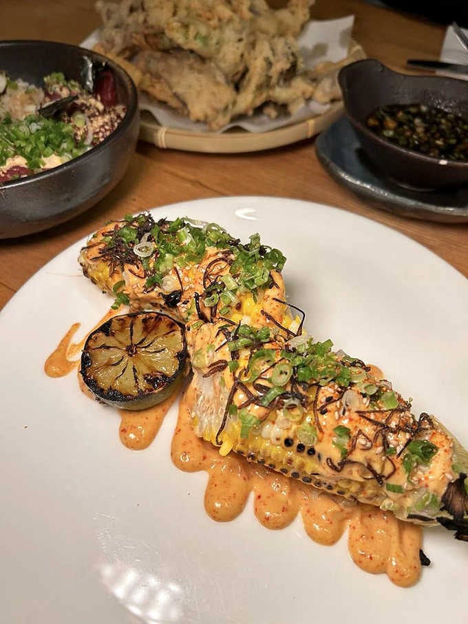 Charred corn dressed to impress with drizzles and garnishes that elevate humble vegetables into something genuinely crave-worthy and memorable.